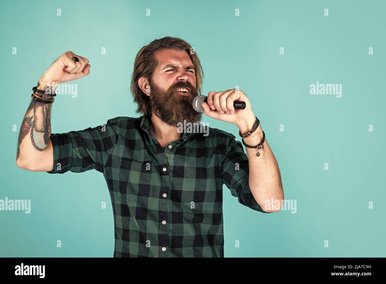 mature bearded man looking casual trendy singing in microphone, party ...