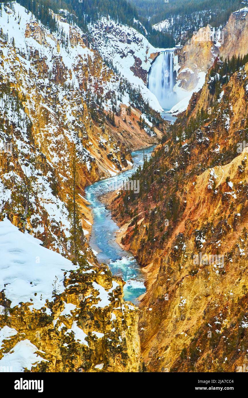 Colorful canyons with Yellowstone Upper Falls with snowy cliffs Stock ...