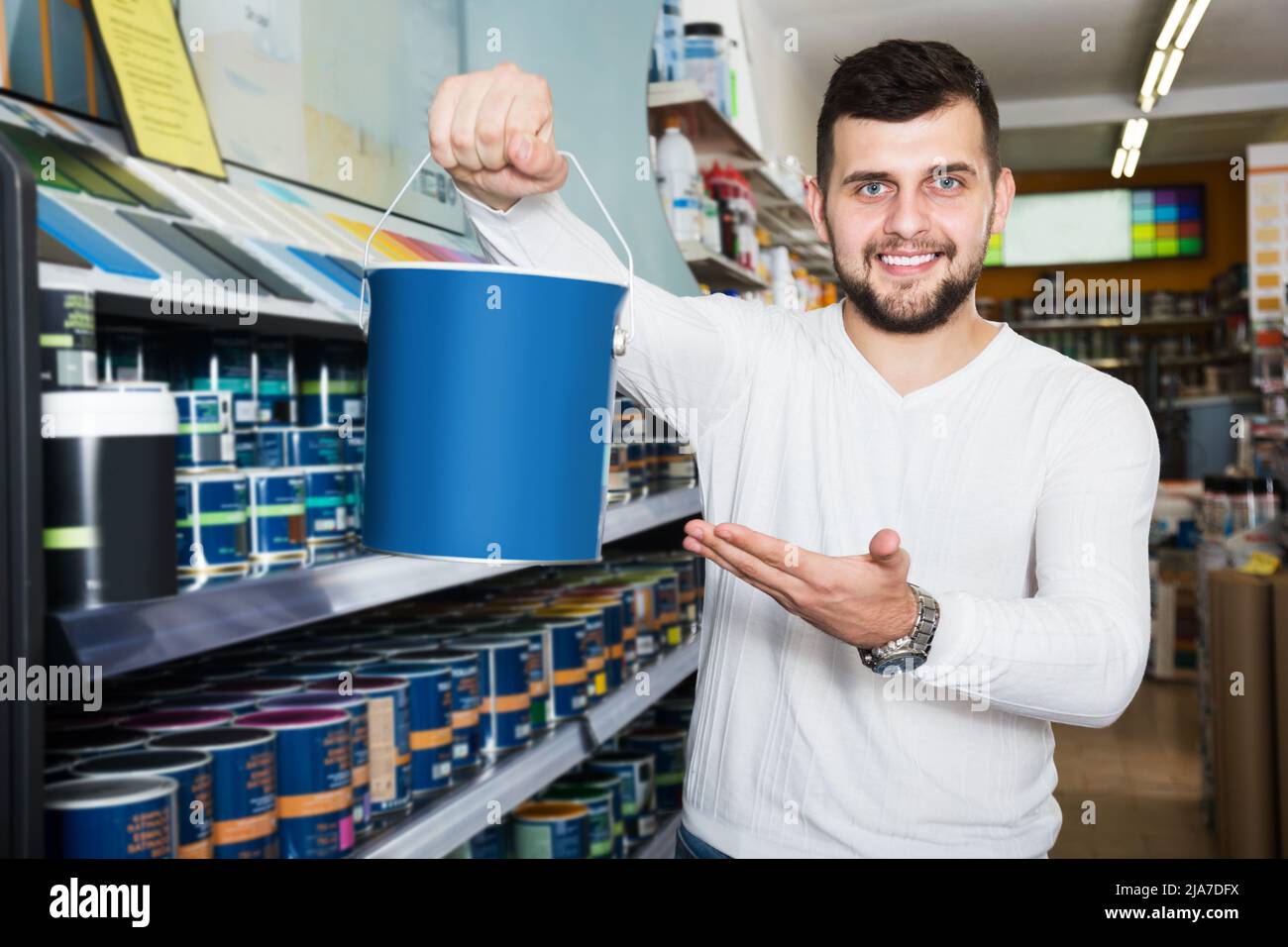 Man choosing wall paint Stock Photo - Alamy