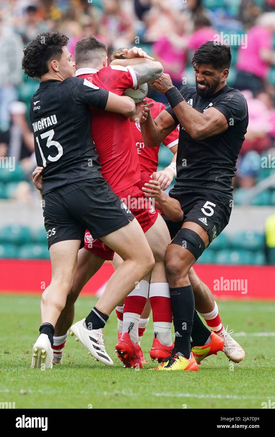 Canada's Nicholas Allen (centre) battles for the ball with New Zealand ...