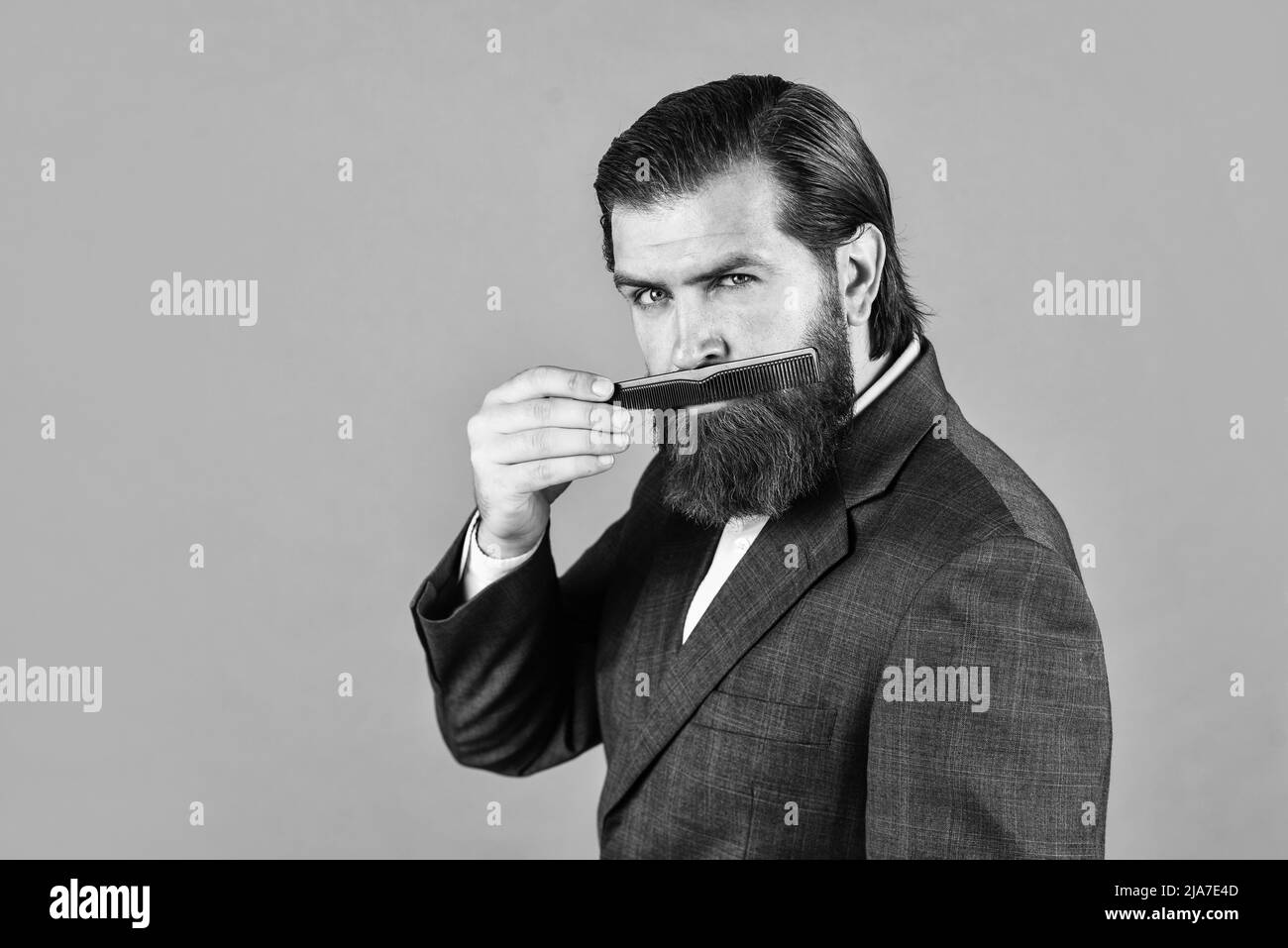 Master grooming hair and beard in the barbershop. hairdresser makes ...