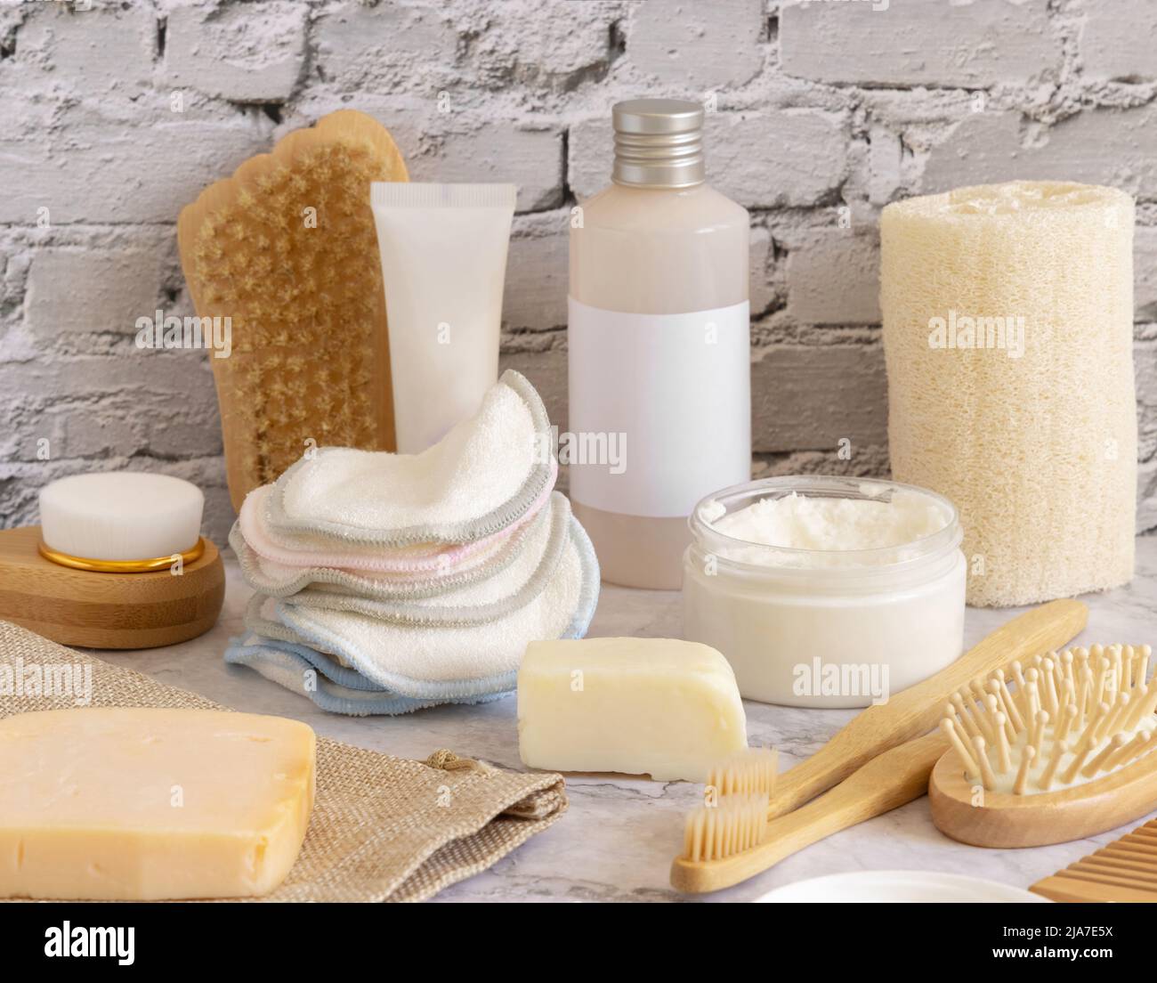 Homemade Skin care cosmetics and bath accessories against white brick ...