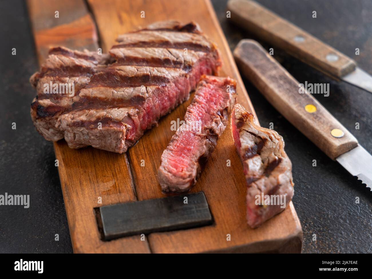 Grilled beef fillet steaks on dark table close up top view. Cooked ...