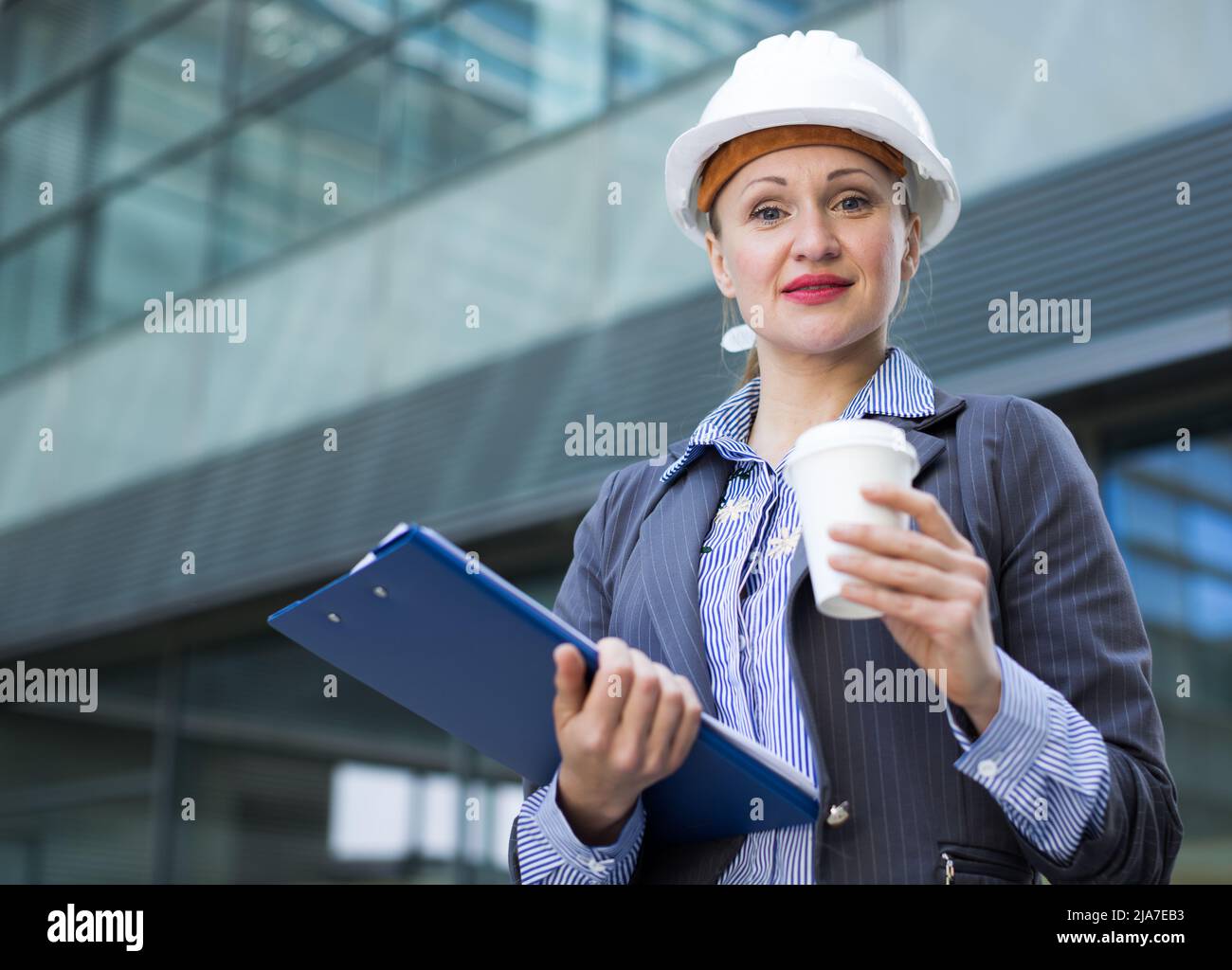 Adult female architect in helmet and coffee Stock Photo - Alamy