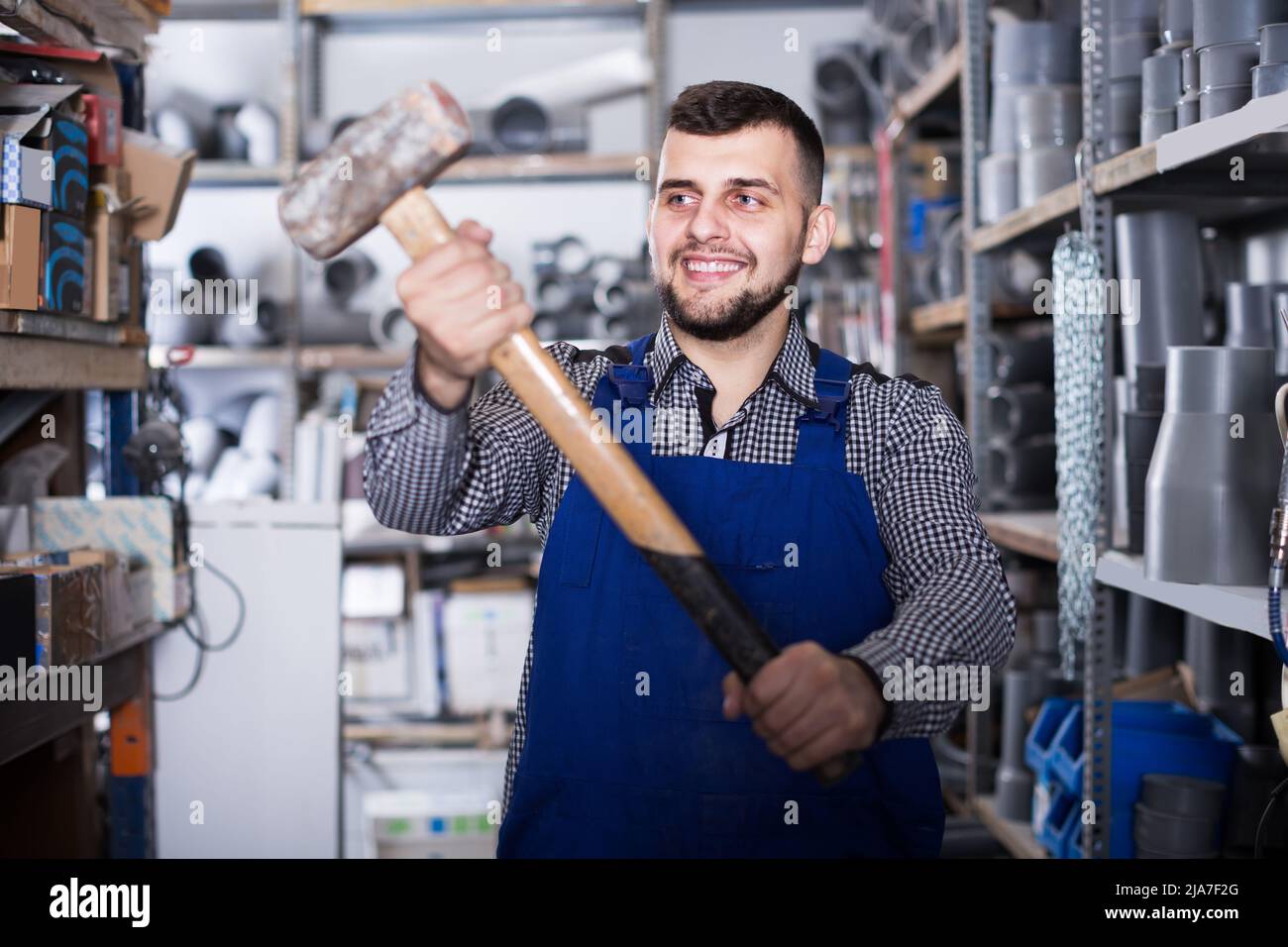 Construction worker display a professional hammer Stock Photo - Alamy