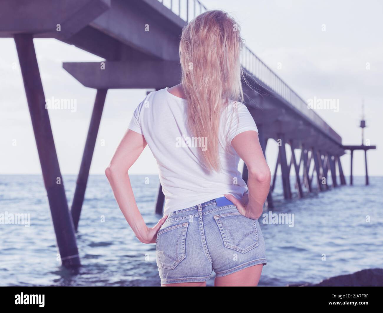 Cheerful female is posing on the rocks in her free time Stock Photo - Alamy