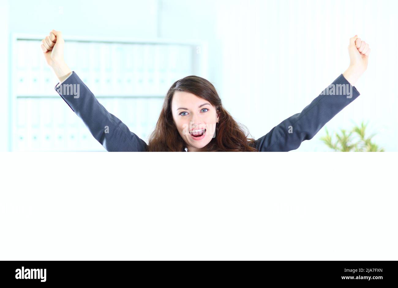 Nice business woman in the office of the shows poster, hands up Stock ...
