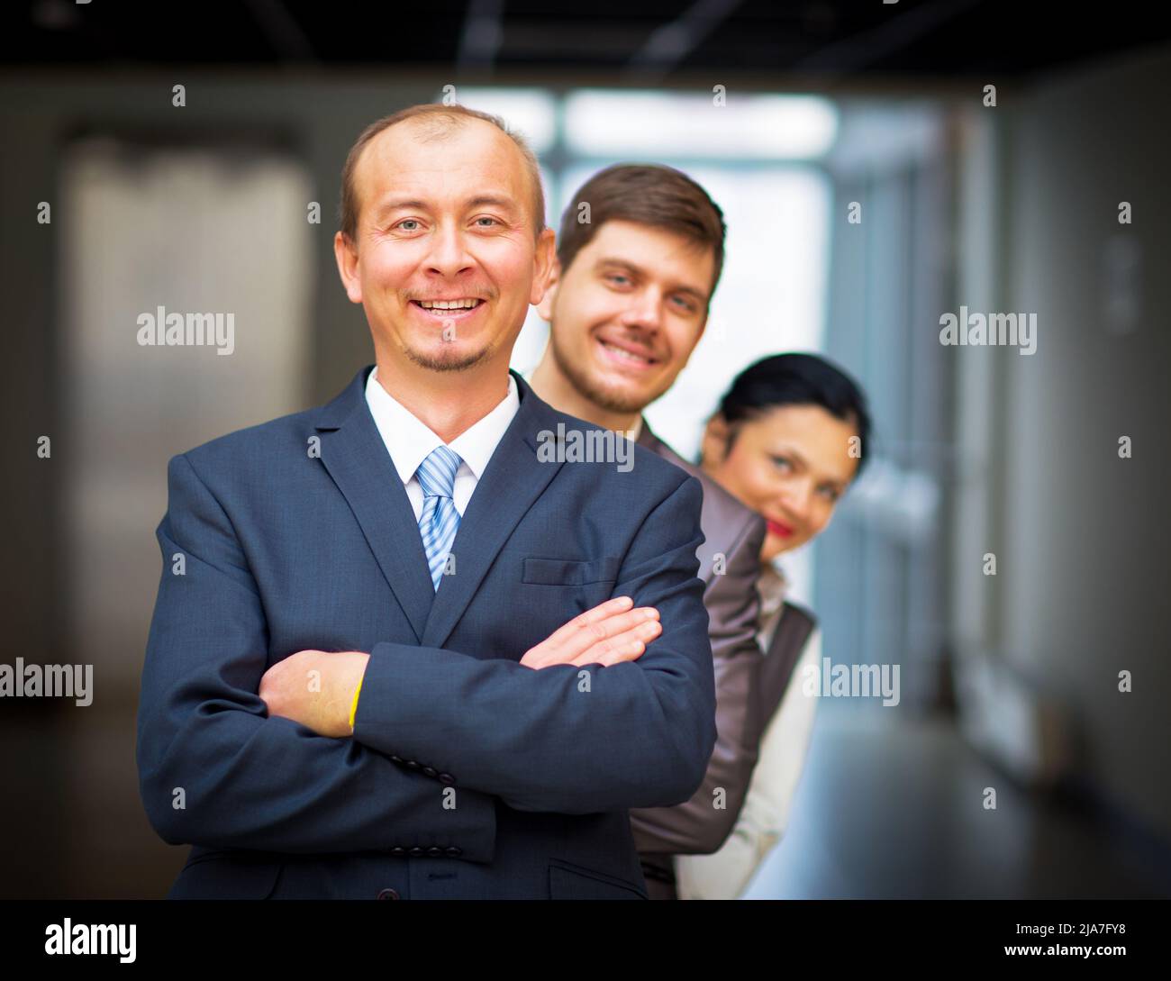 smiling employees standing around their manager Stock Photo - Alamy
