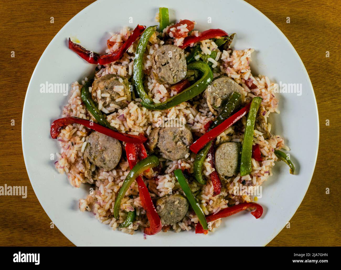 rice served with sauteed peppers and sausages Stock Photo - Alamy