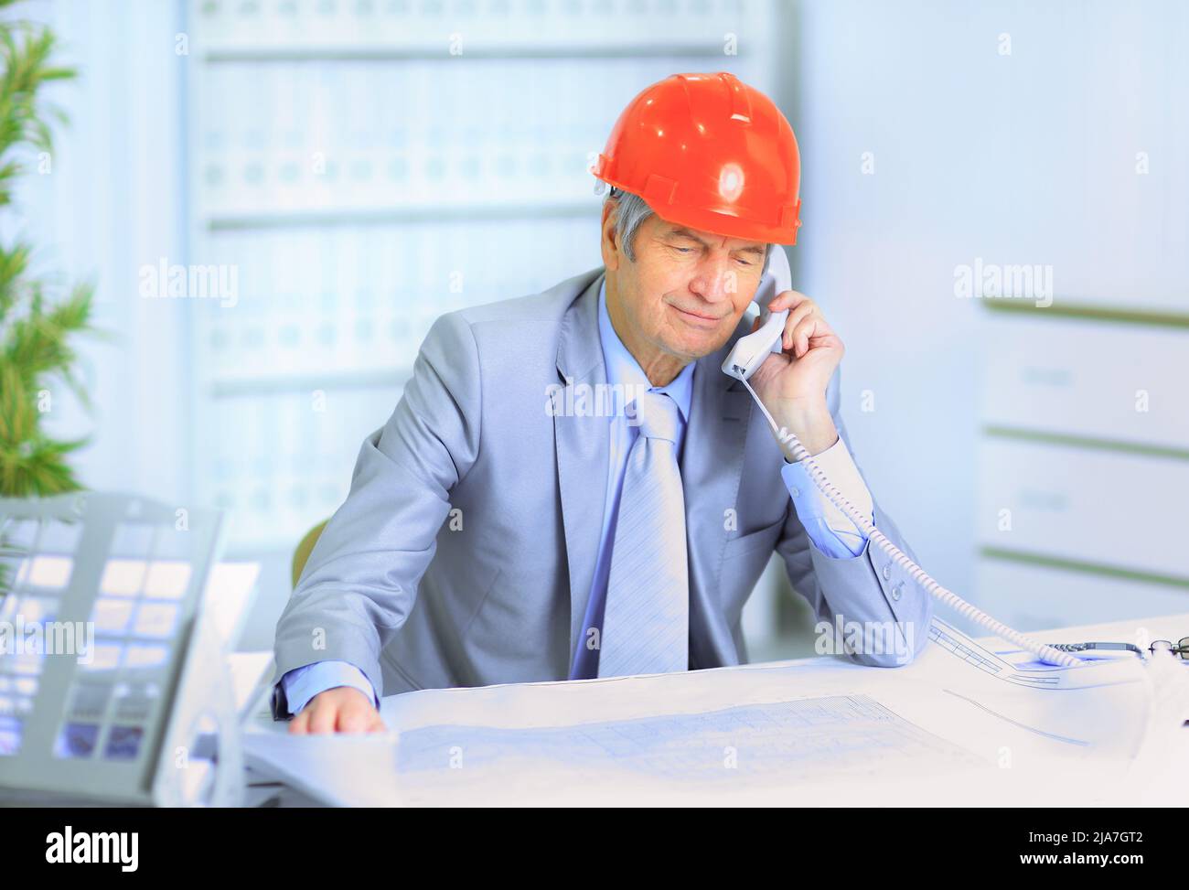 Engineer at the age of talking on the phone about the plans of the ...