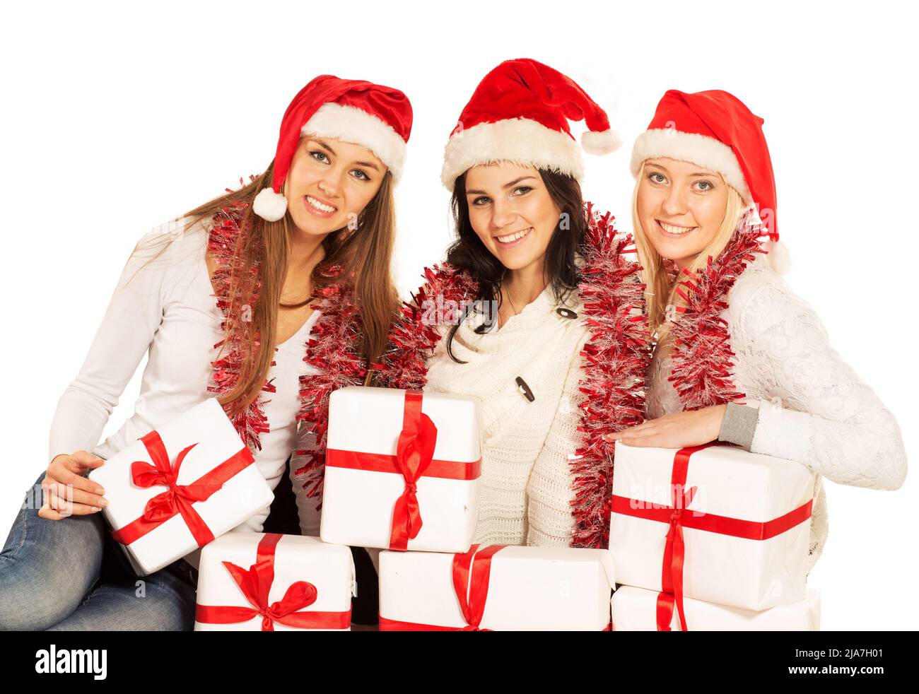three happy girls with Christmas gifts and decorations Stock Photo - Alamy