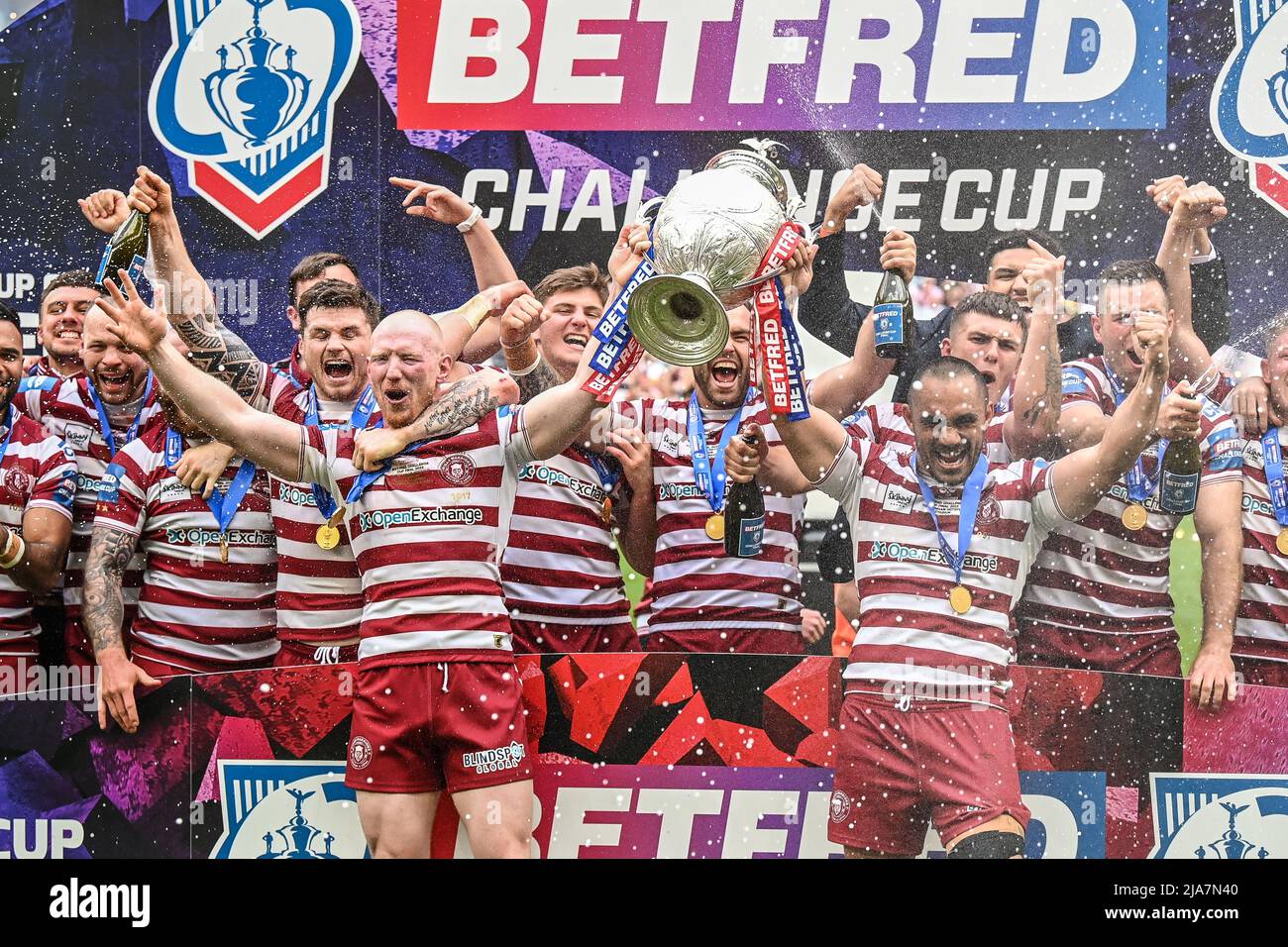 Liam Farrell #12 and Thomas Leuluai #7 of Wigan Warriors , lift the ...