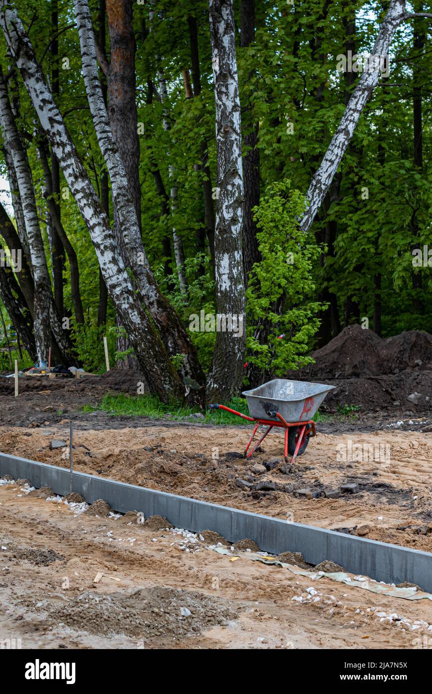 construction wheelbarrow stands on the site of the construction of the ...