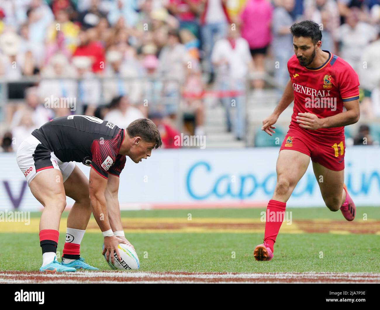 Wales' Ewan Rosser (left) scores a try in front of Spain's Tiago Romero ...