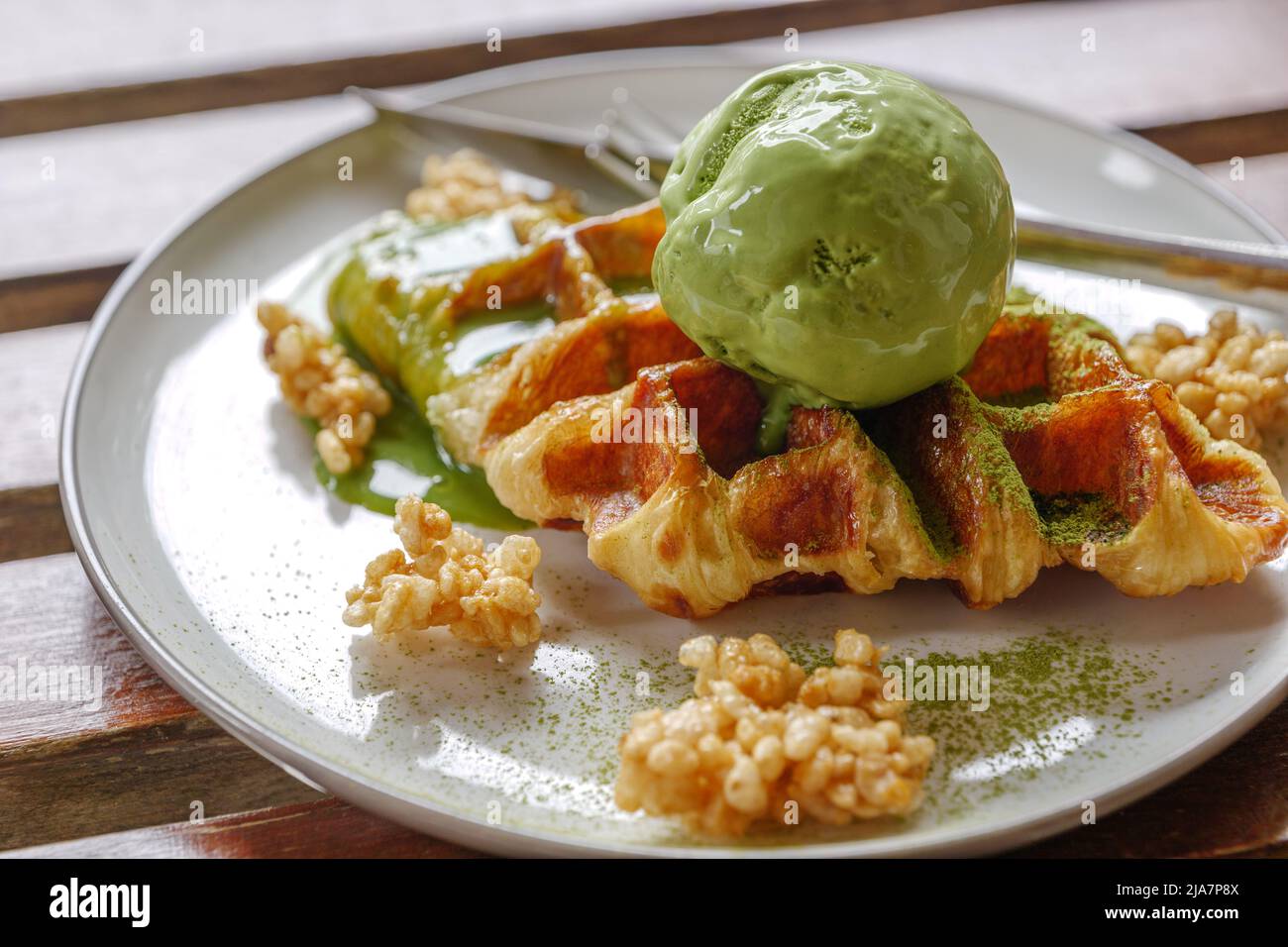 Matcha Green tea ice cream on croissant waffles Stock Photo - Alamy