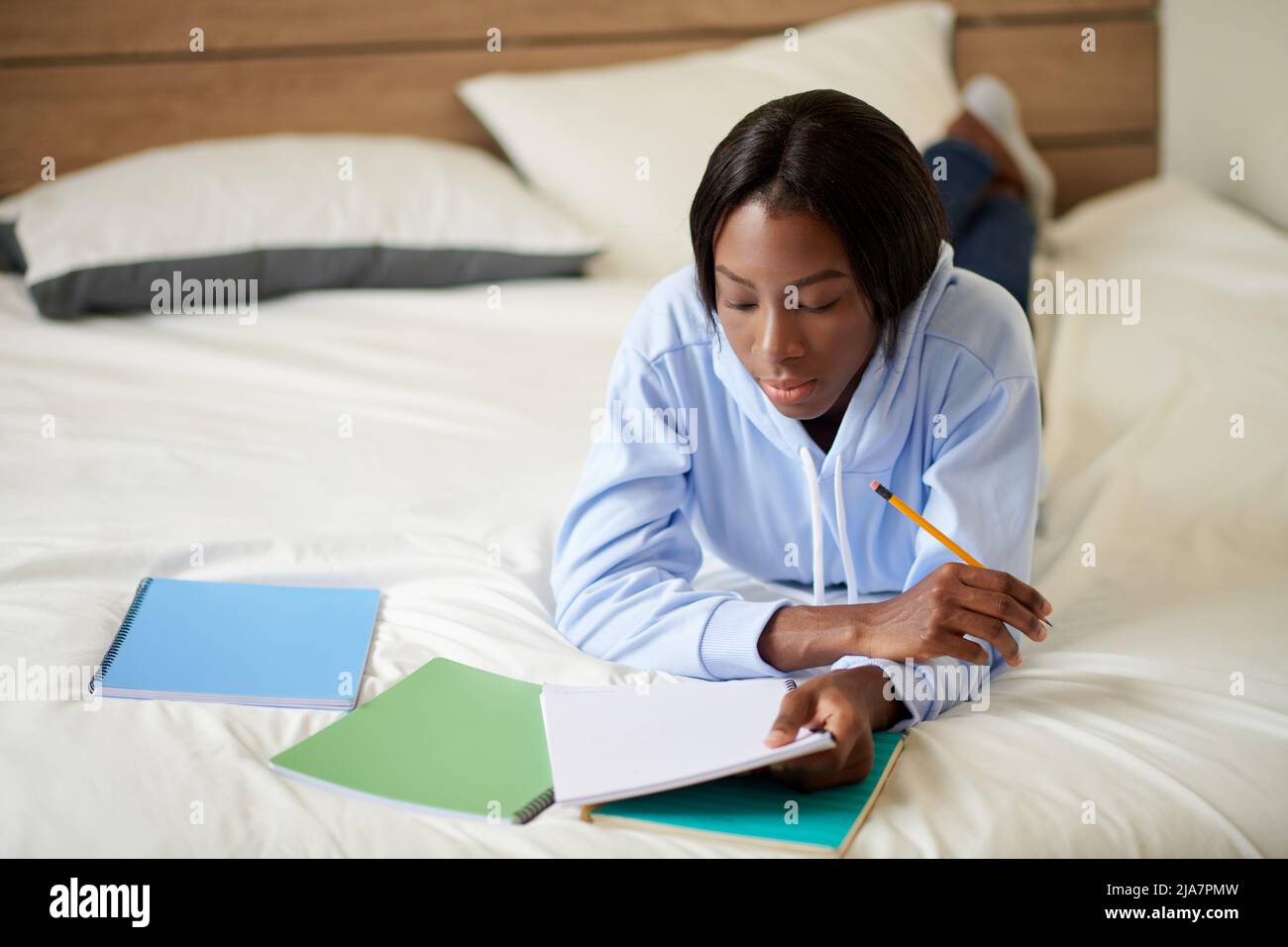 Female college student suffering from lack of inspiration when writing ...