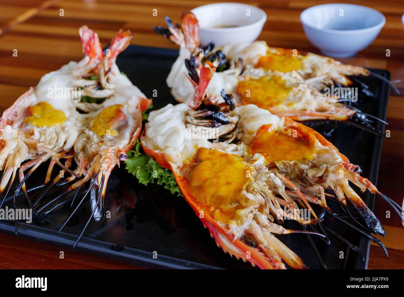 Cutting half grilled giant river prawn, famous local Thai luxury fine ...