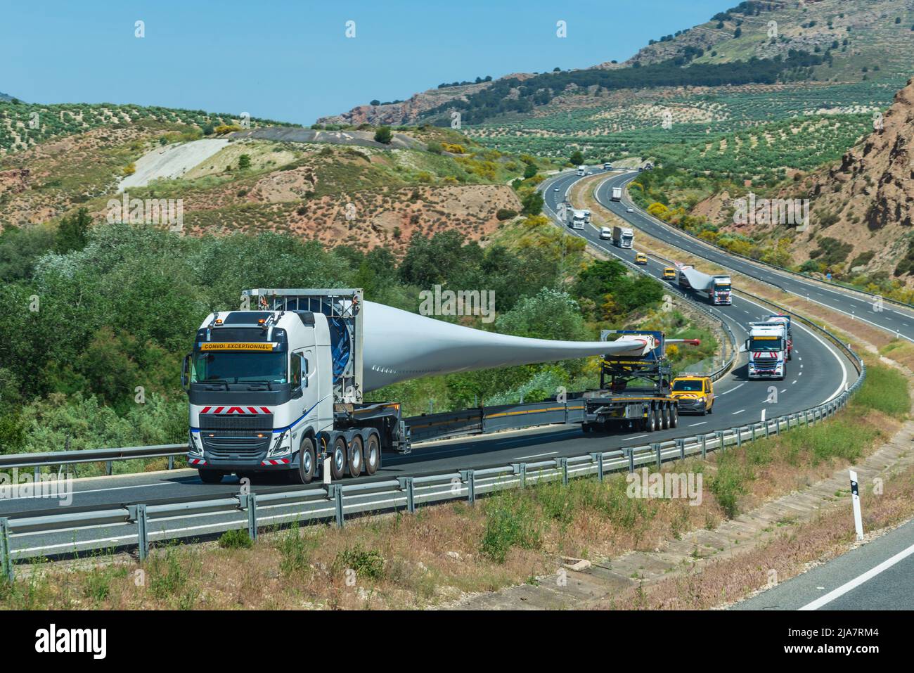 Convoy of trucks transporting wind turbine blades Stock Photo - Alamy