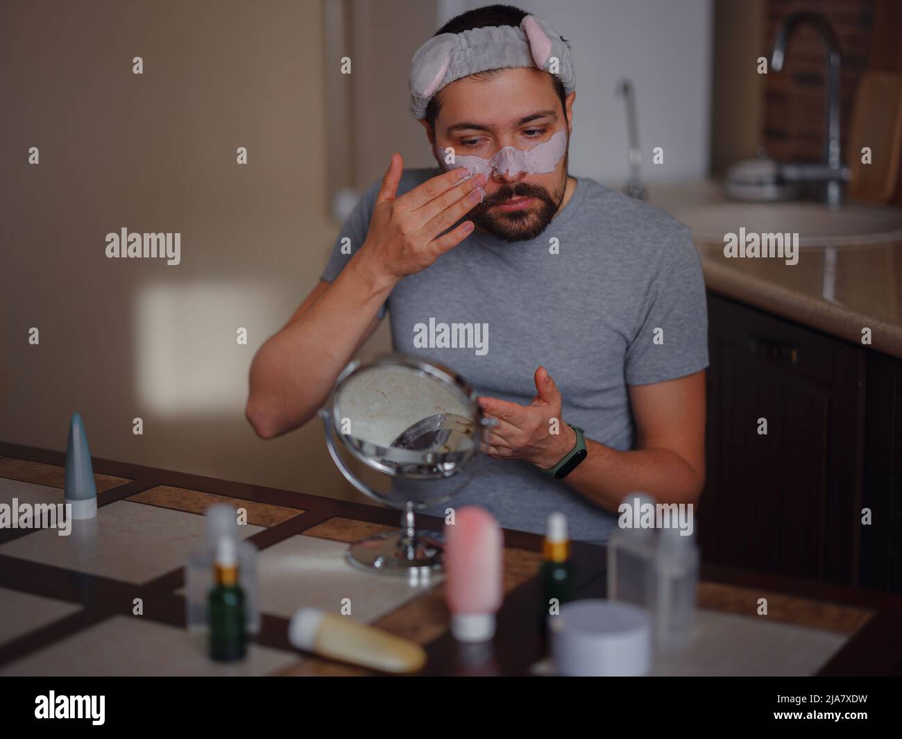 Men's beauty concept. caucAsian guy checking his skin. man looking into ...