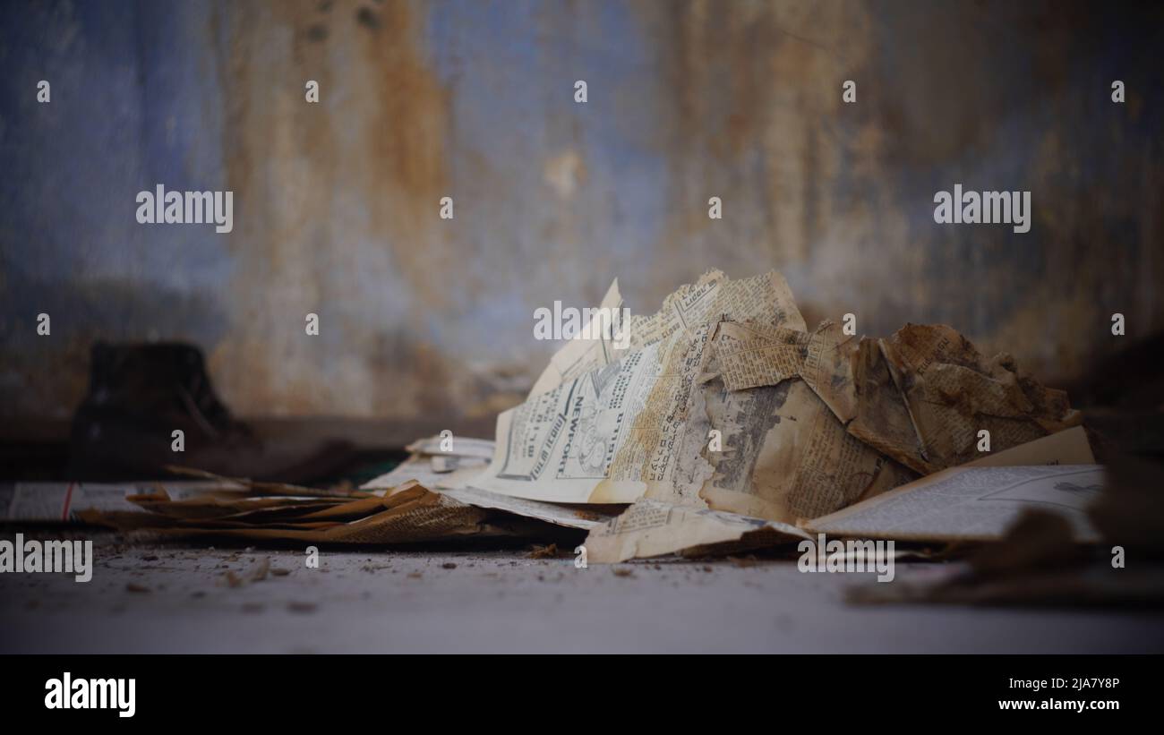 An old abandoned building with old newspapers on the floor Stock Photo ...