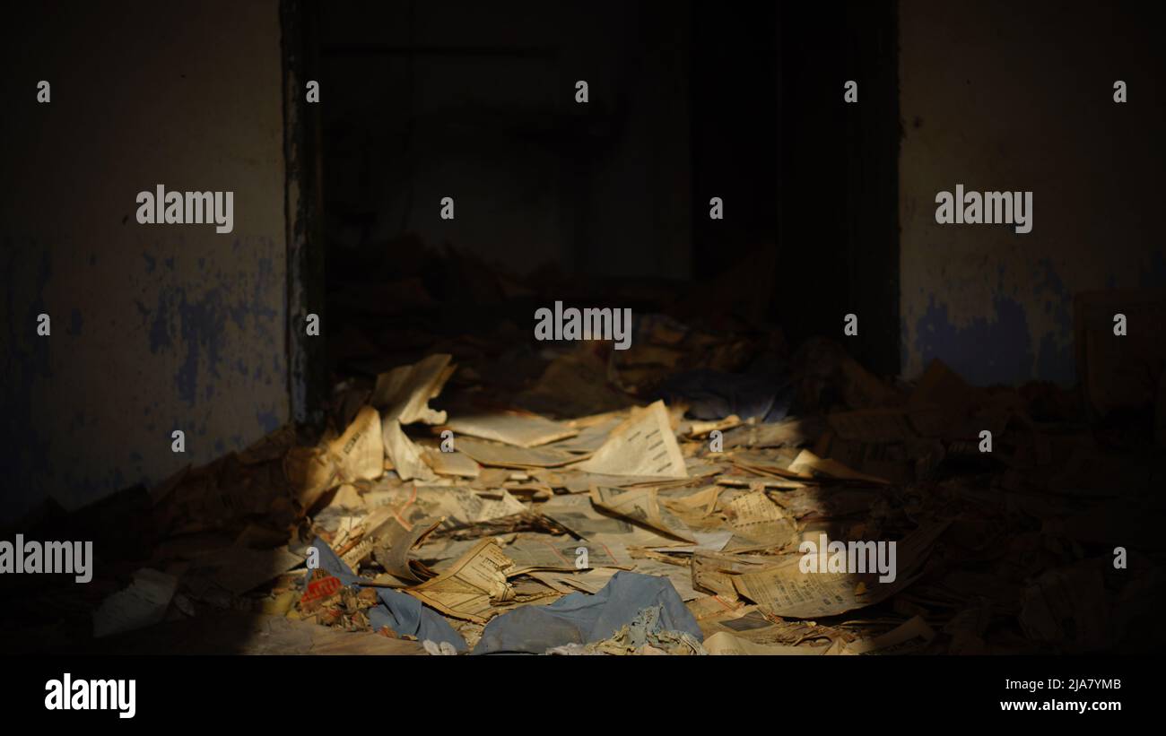 An old abandoned building with old newspapers on the floor Stock Photo ...