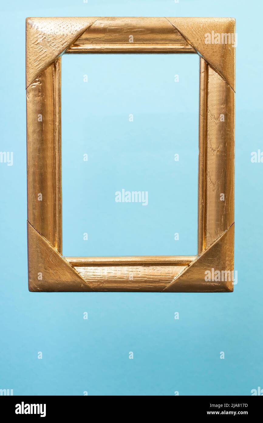Golden empty frame levitating on light blue background Stock Photo - Alamy