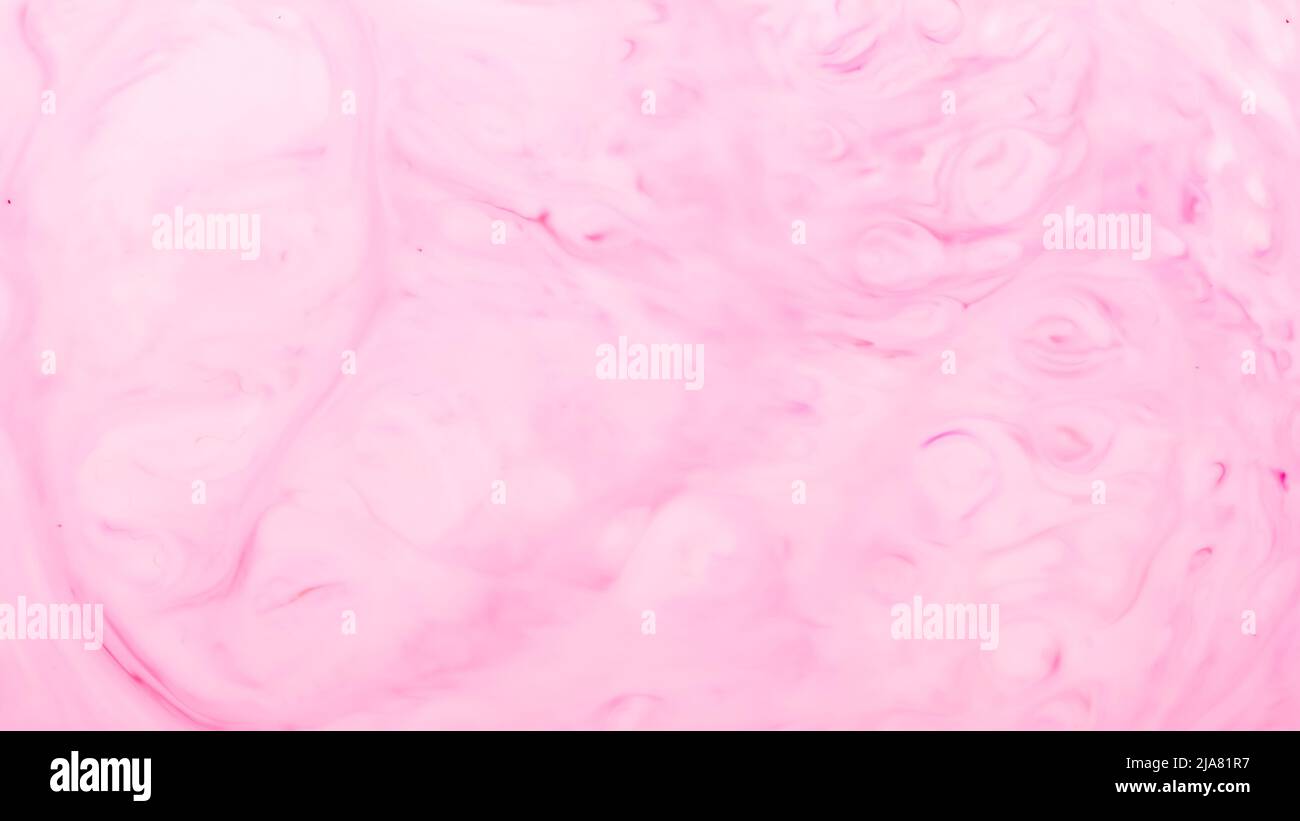 Light pink fluid art background. Blurred pink shapes on a liquid ...