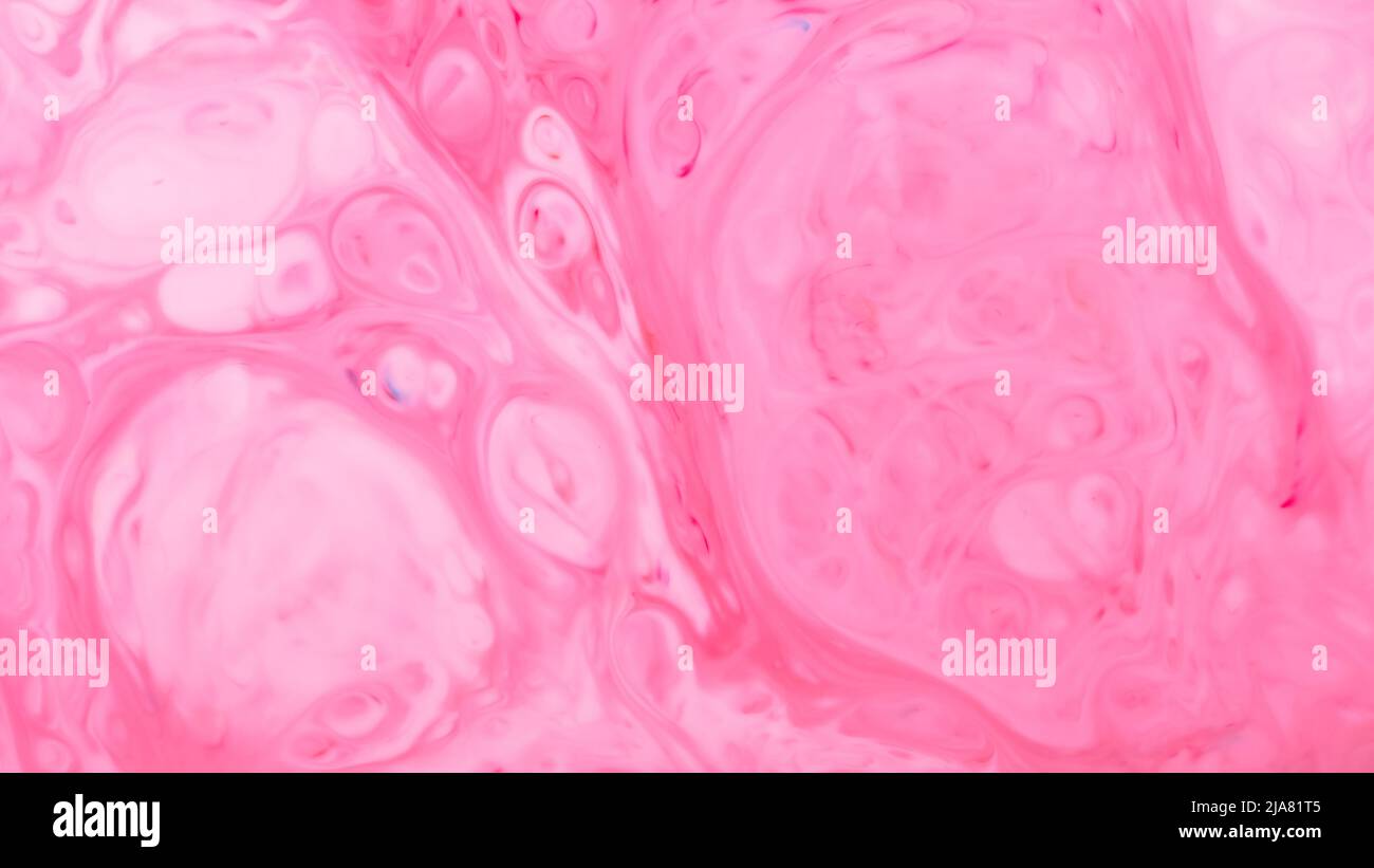 Light pink fluid art background. Blurred pink shapes on a liquid ...