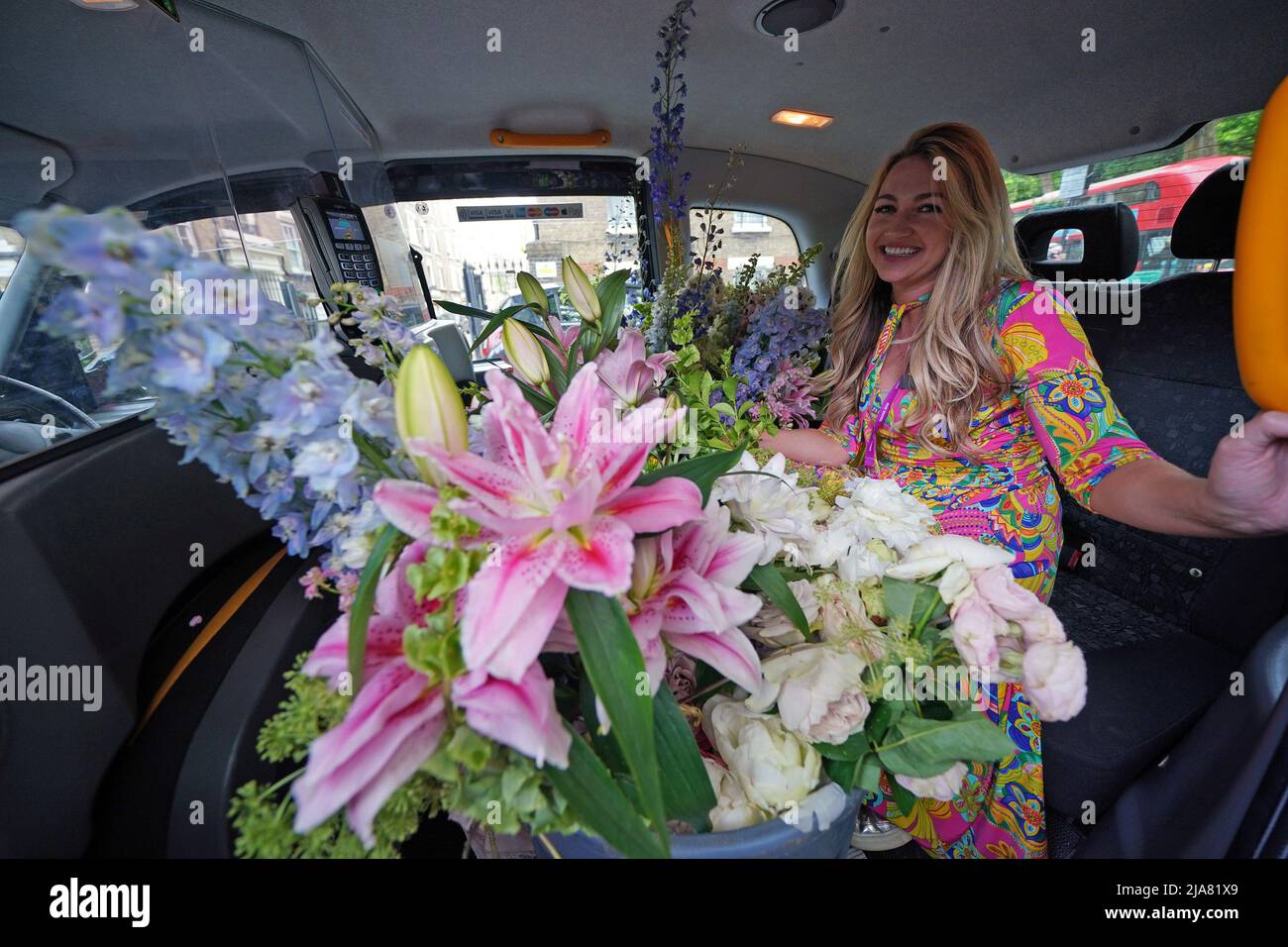 Visitor Sarah Hart in a taxi loaded with her flower purchases - bought ...