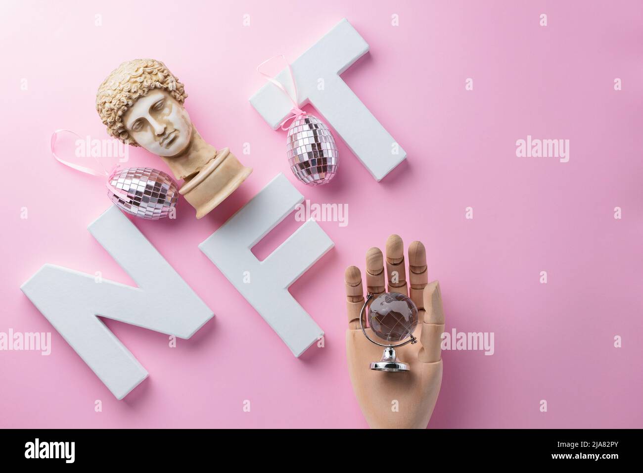 NFT (Non-Fungible token) and antique sculpture on a pink background ...