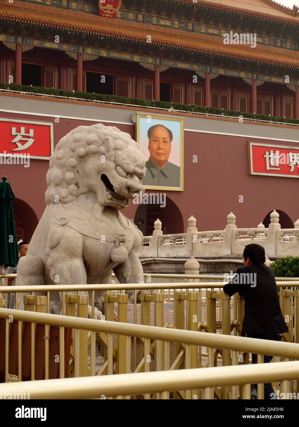 A marble lion and the portrait of Mao Zedong guard the entrance to the ...