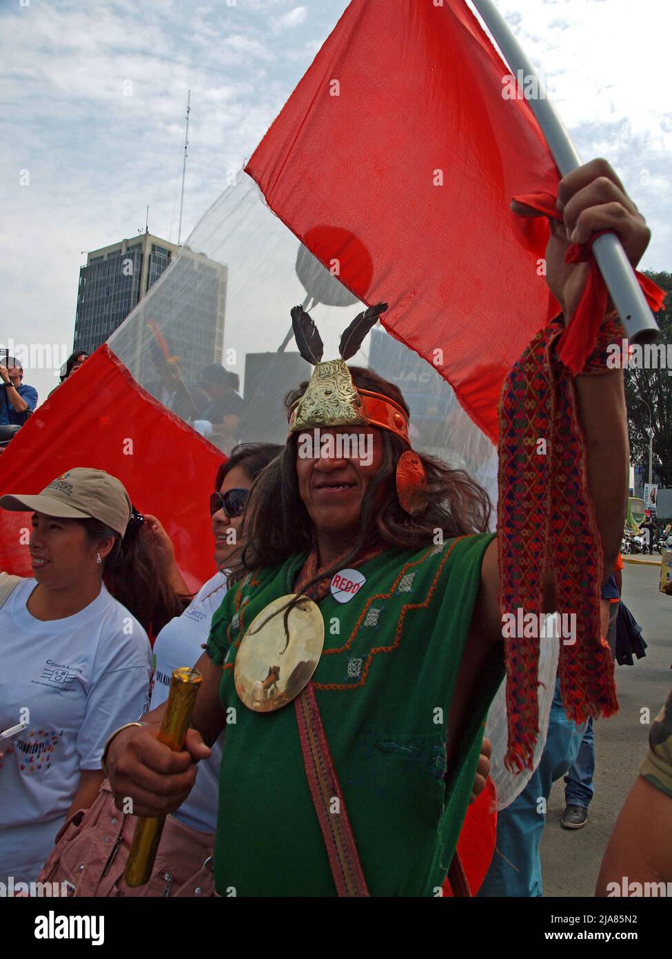 An indigenous man disguised as an Inca and carrying a Peruvian flag ...