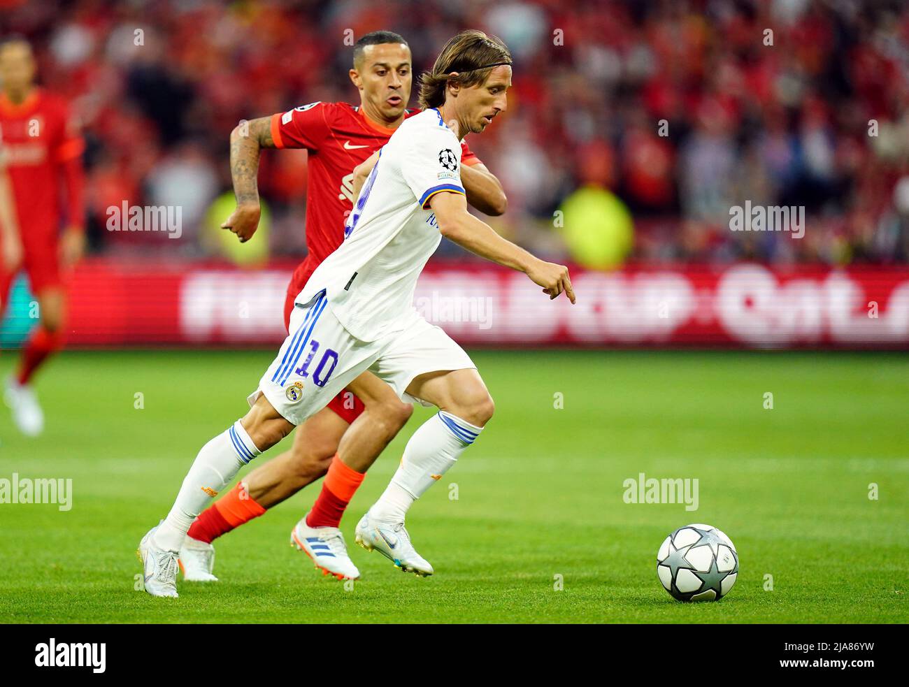 Real Madrid's Luka Modric tries to get away from Liverpool's Thiago ...