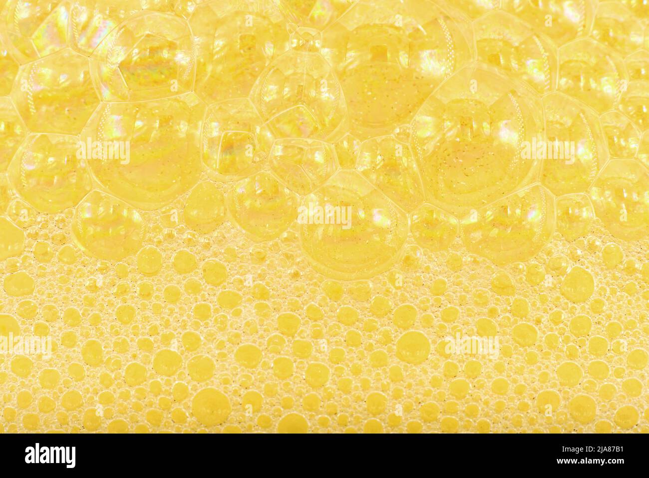 Soap foam close-up. Texture of soapy shampoo in yellow color Stock ...