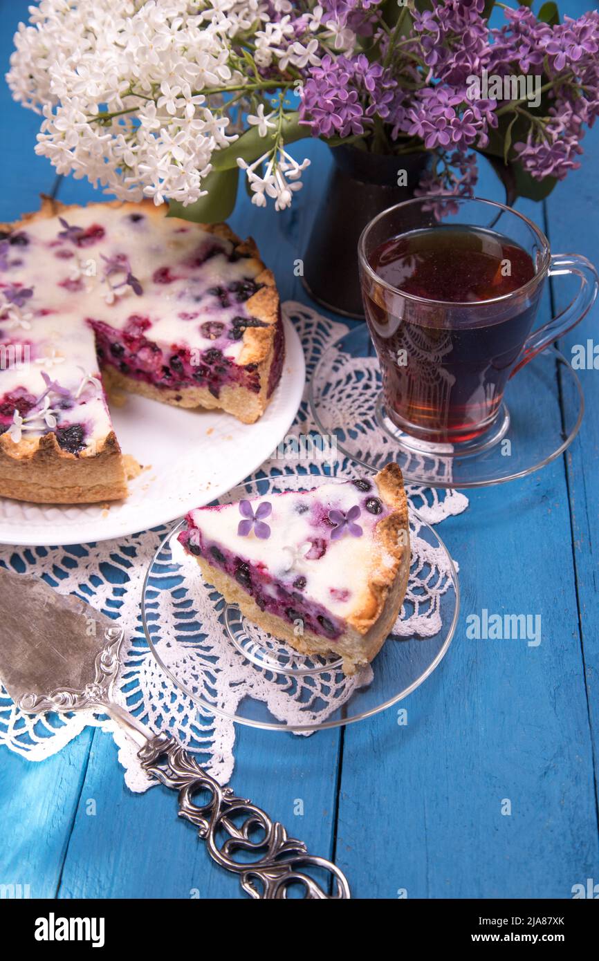 Summer shortbread pie with berries and a bouquet of lilacs. Homemade ...