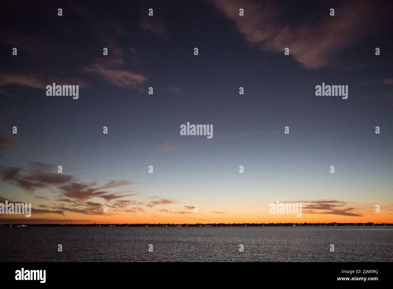 Phases of a sunset on the ocean with the sun reflected in the water ...