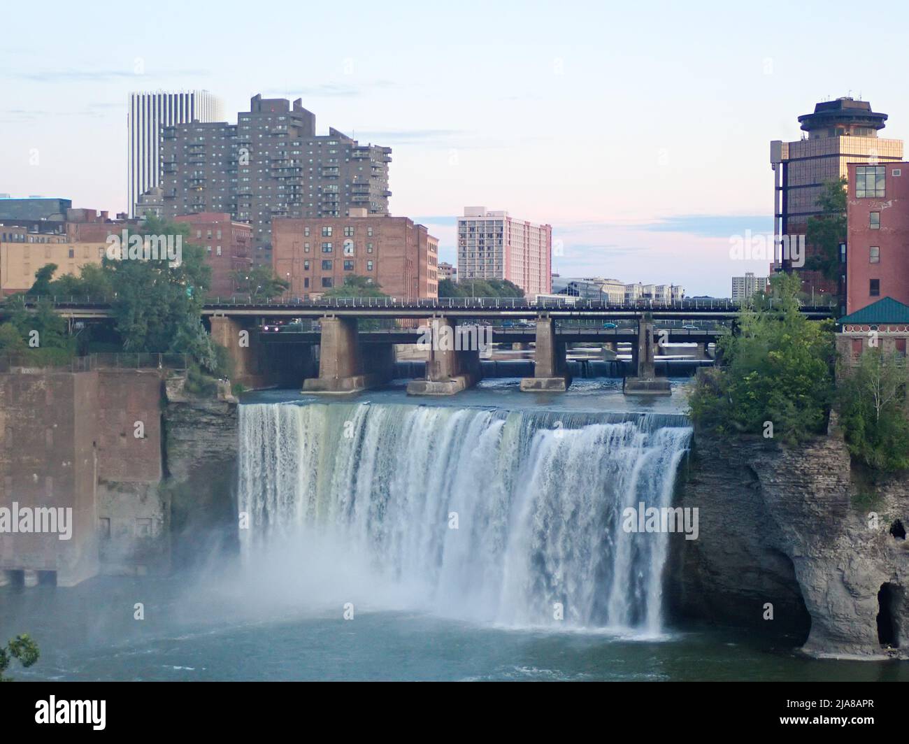 The Genesee River flowing under a bridge and over the Court Street Dam ...