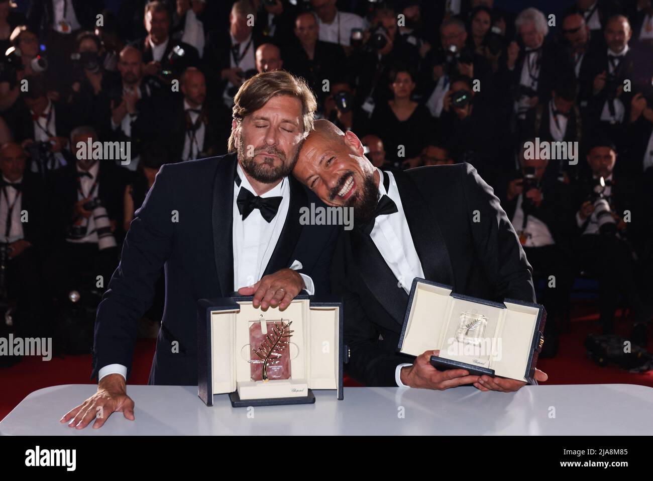 Ruben Ostlund poses with the Palme D'or Award for "Triangle of Sadness" and Tarik Saleh during ...