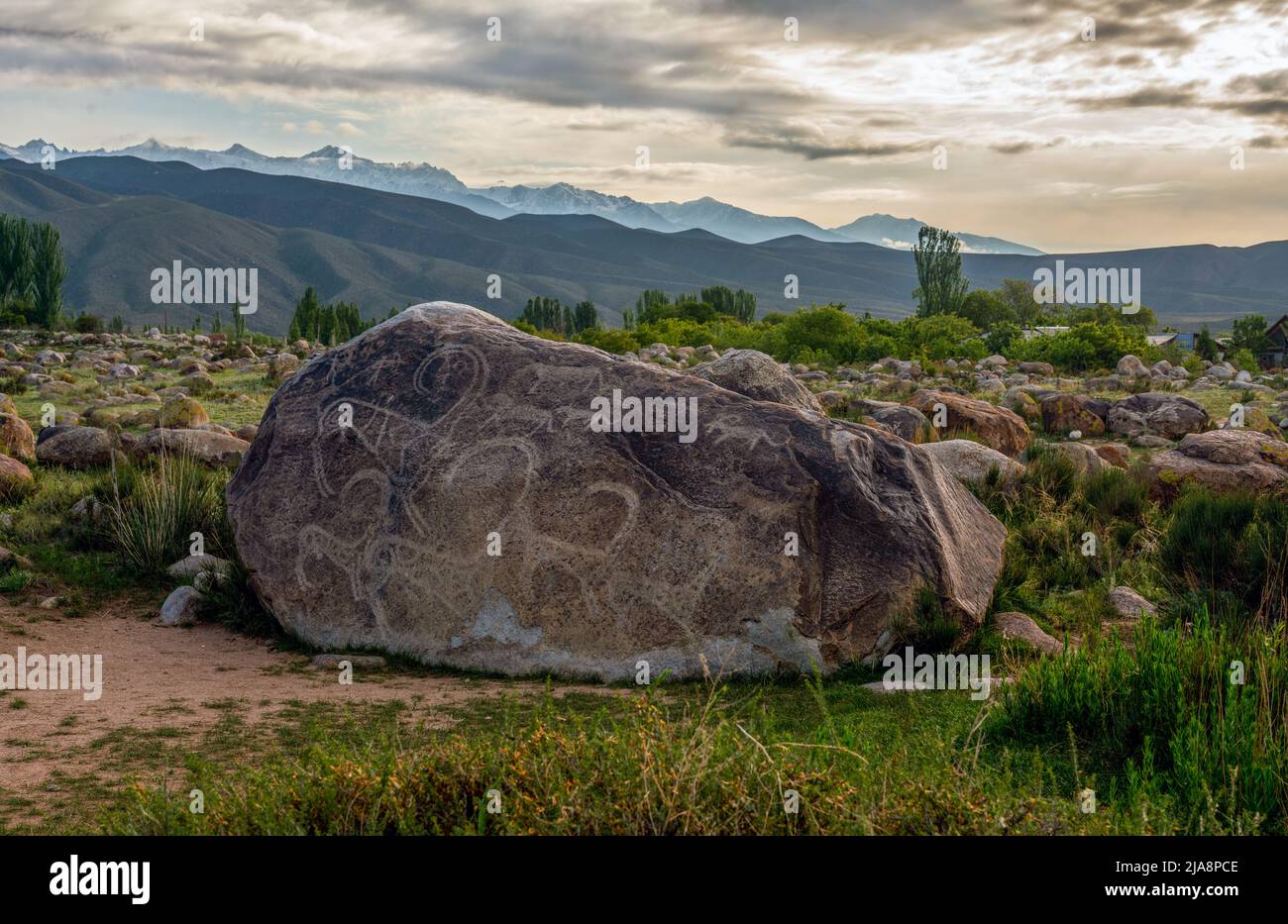 A wonderful view of a rock with petroglyphs (depicting ancient hunting ...