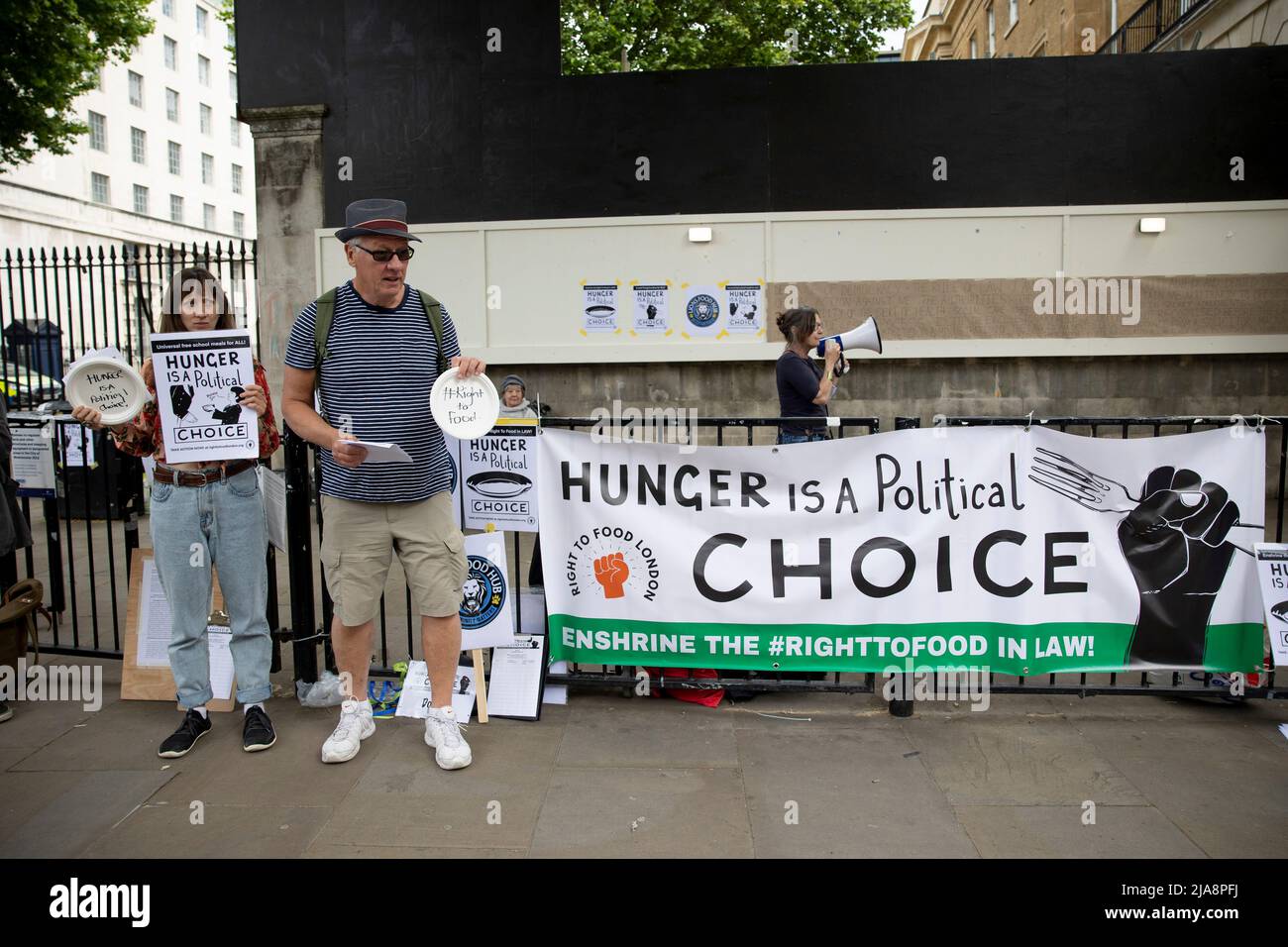 London, UK. 28th May, 2022. Protesters are seen with signs and a banner ...