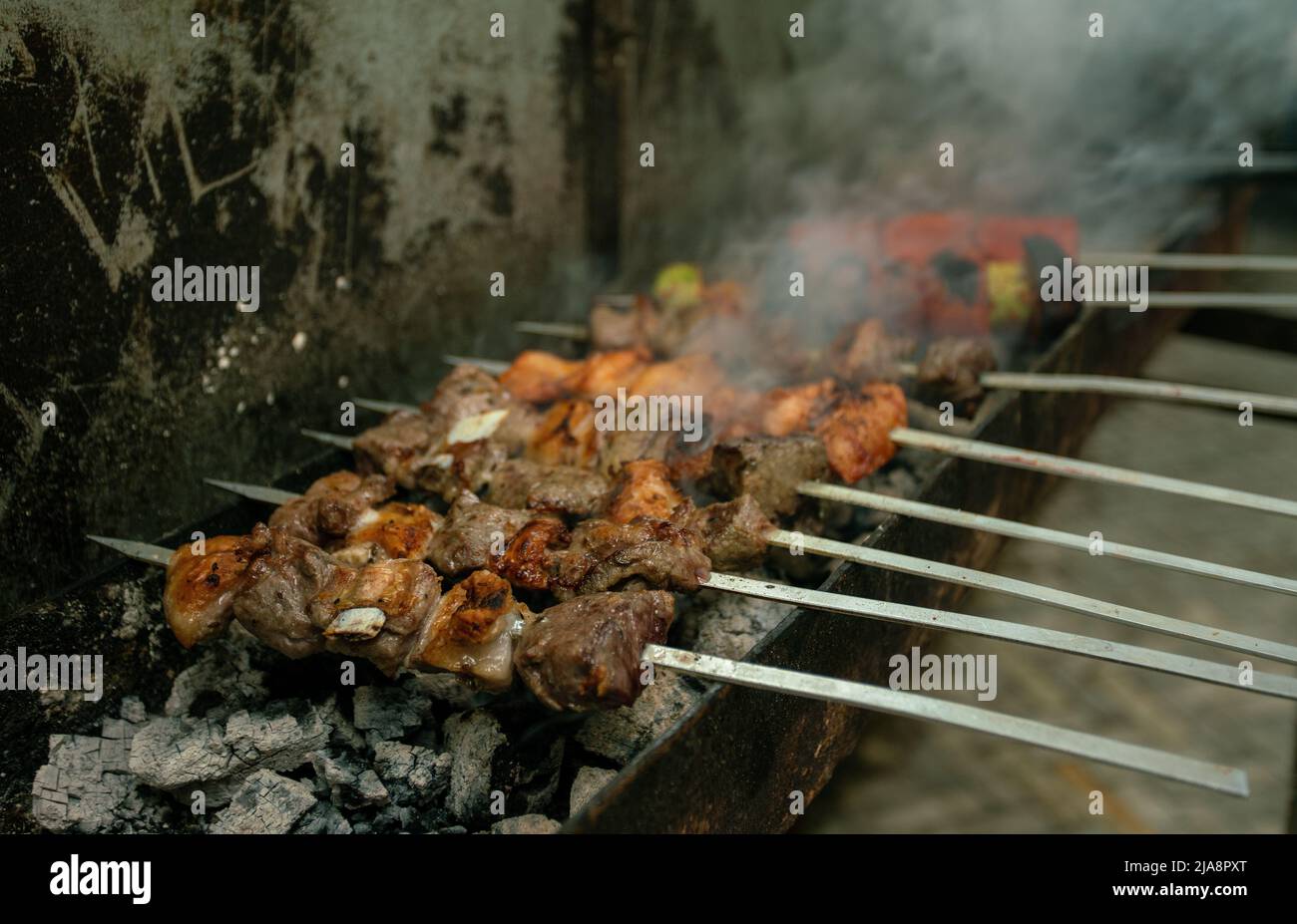 Lamb shish kebab is grilled on a barbecue open fire or rather hot ashes ...