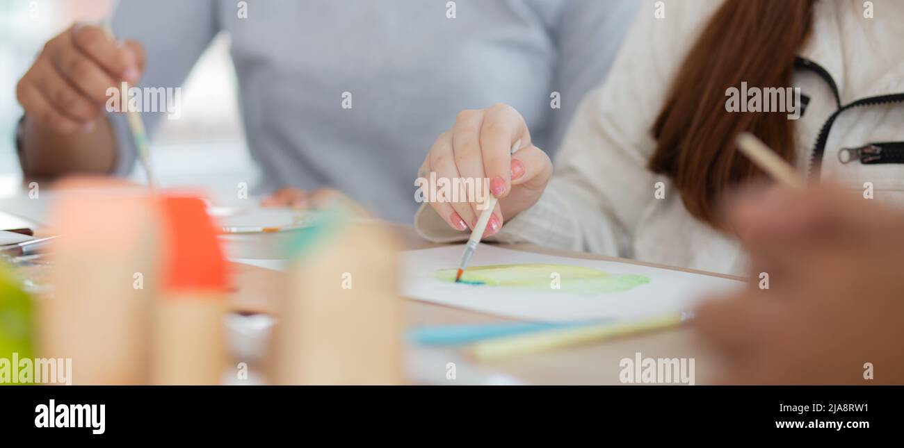 Closeup group of student sitting and studying and learning drawing with ...