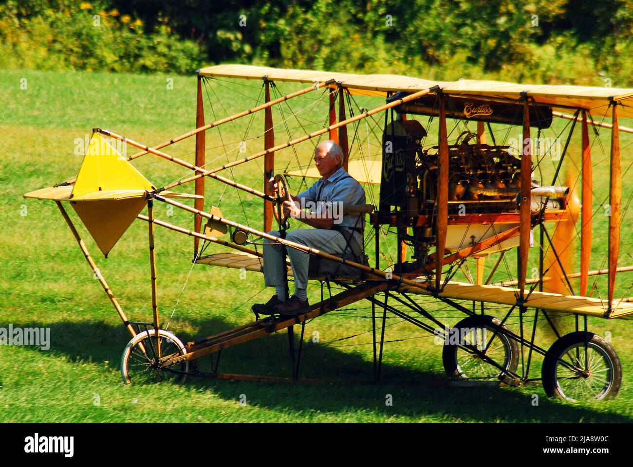 A senior man pilots an antique Curtis Pusher Model D to the runway at ...
