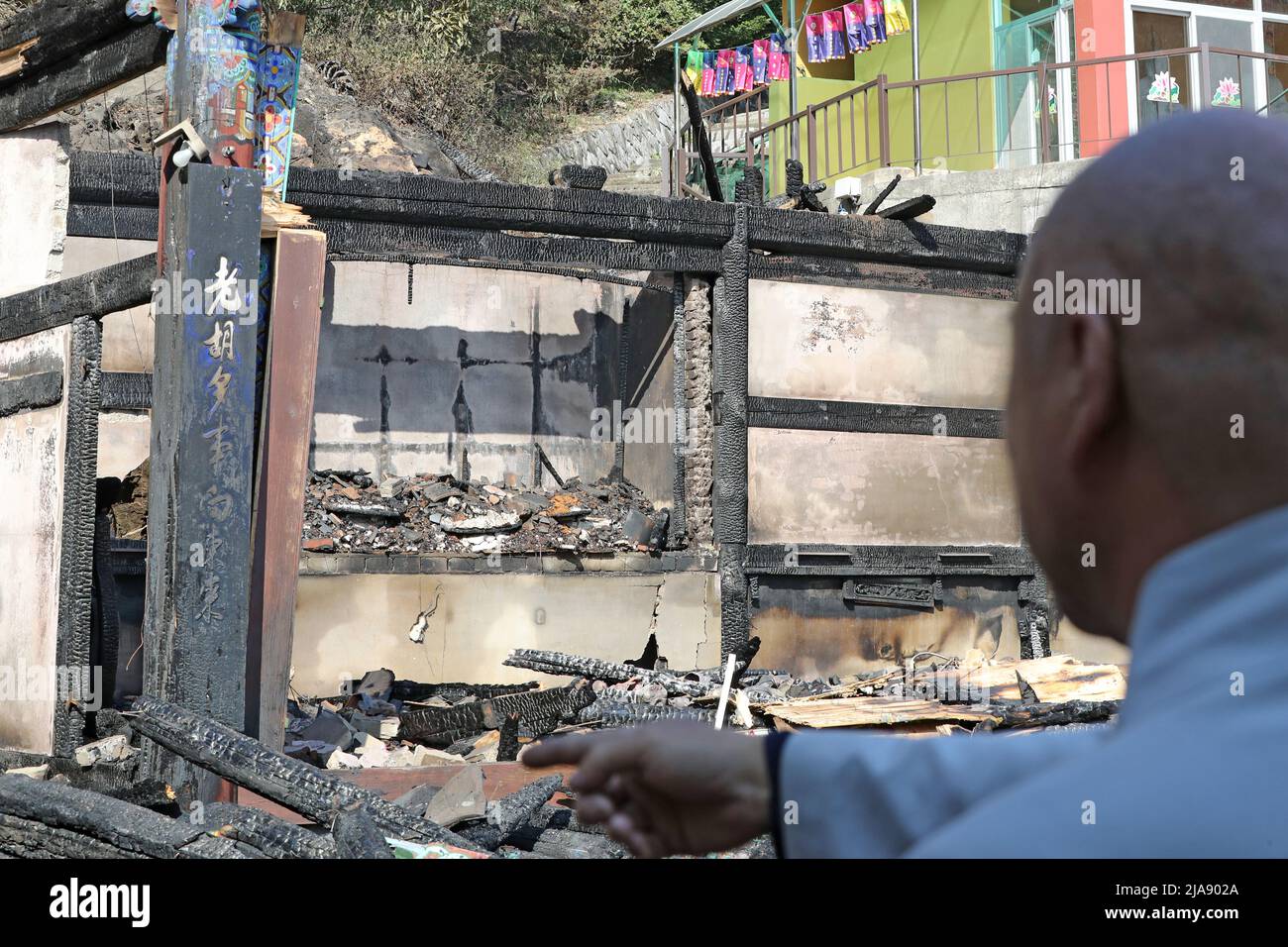 29th May, 2022. Destroyed temple A Buddhist monk looks around the ...