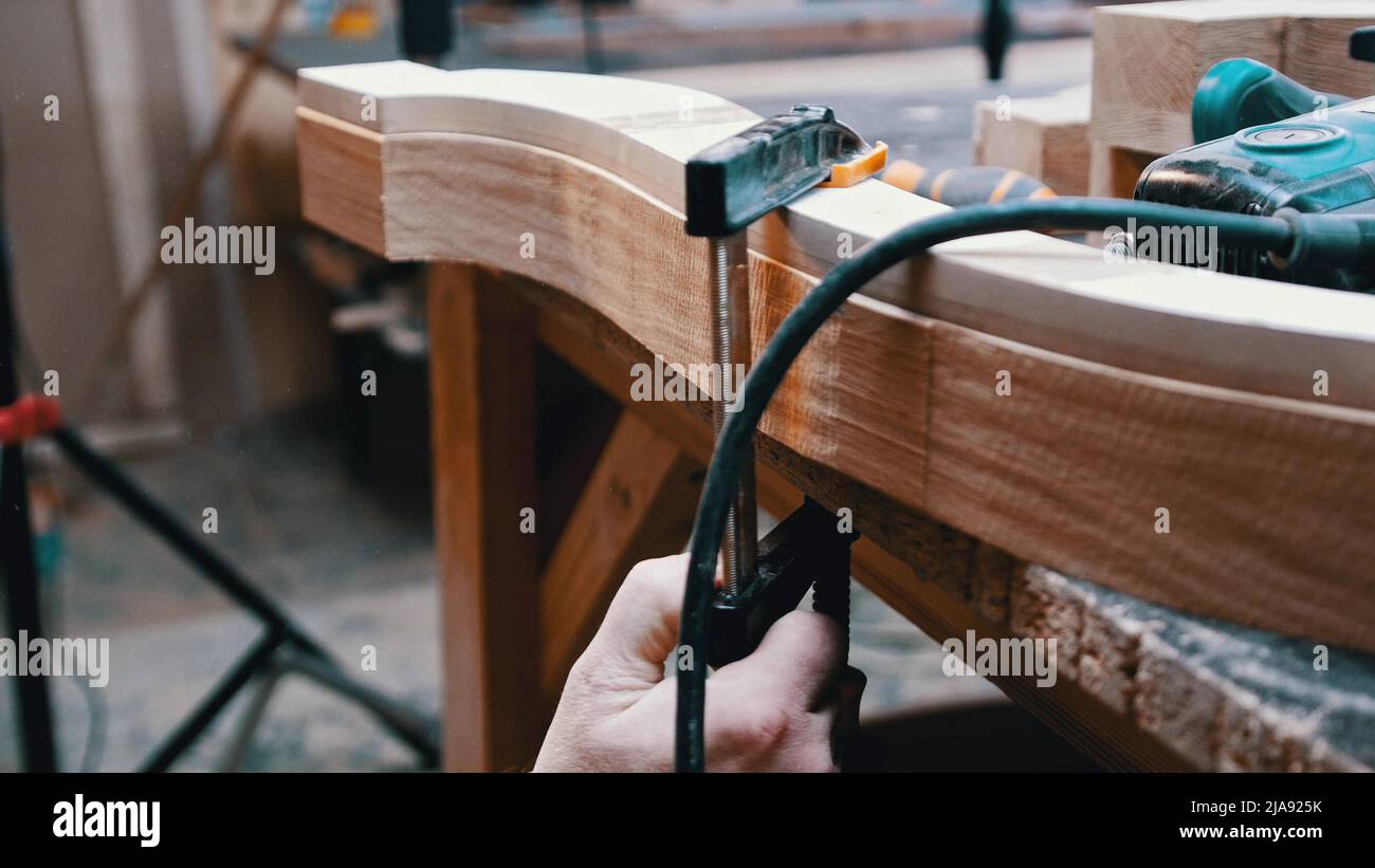 Carpentry - a man woodworker measuring the detail width Stock Photo - Alamy
