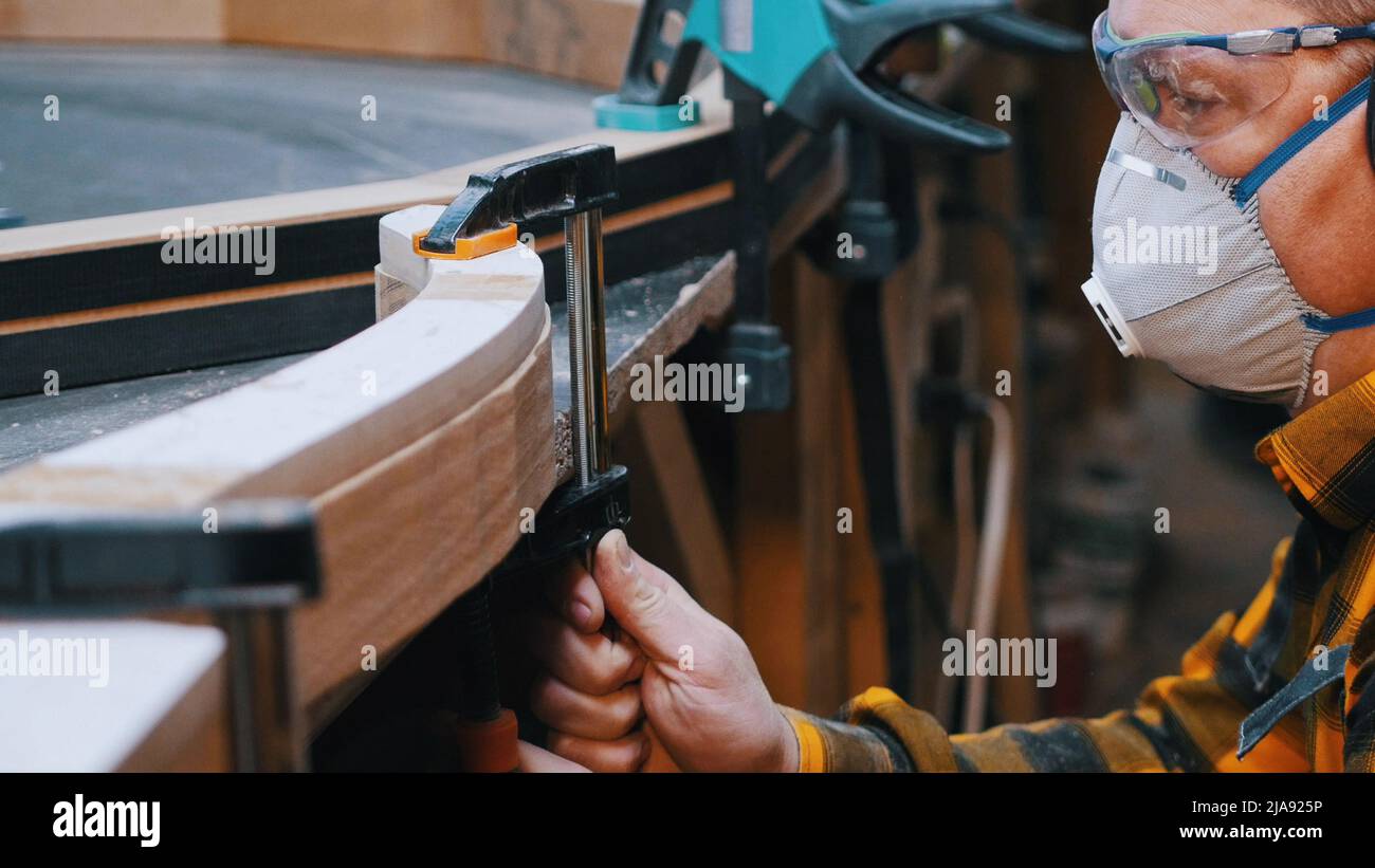 Carpentry - a man woodworker measuring the wooden detail width Stock ...