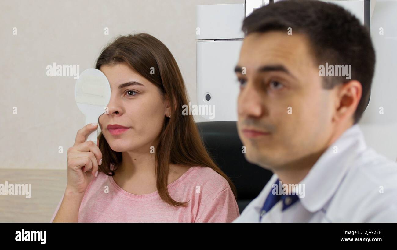 Ophthalmology treatment - young woman checking her visual acuity ...