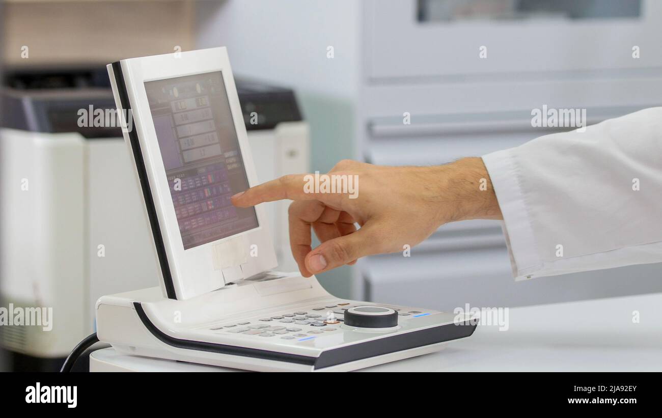 Ophthalmology treatment - a doctor working with a special equipment for ...