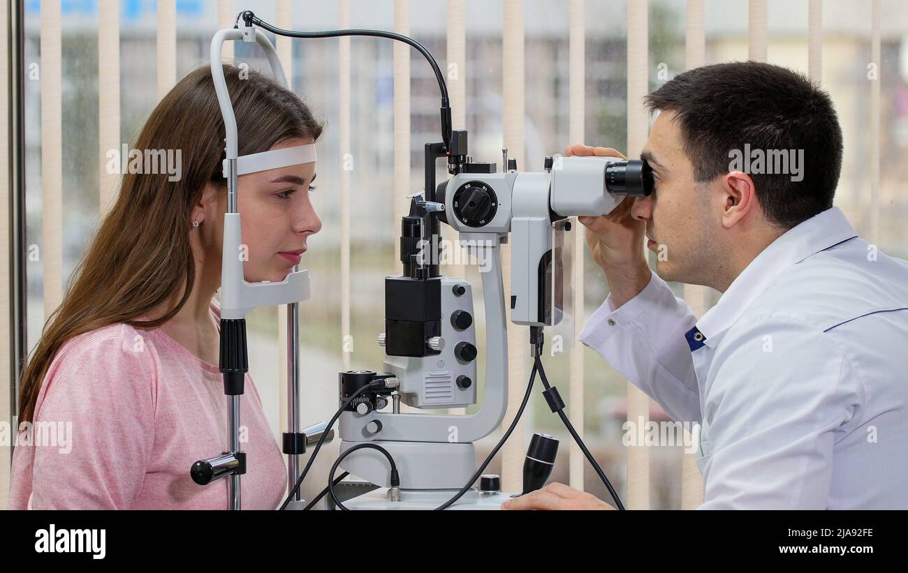 Ophthalmology treatment - young smiling woman checking her visual ...