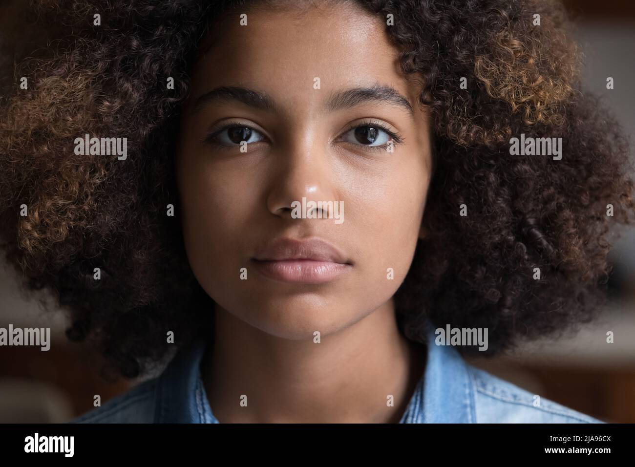 Calm serious beautiful millennial African woman looking forward without ...